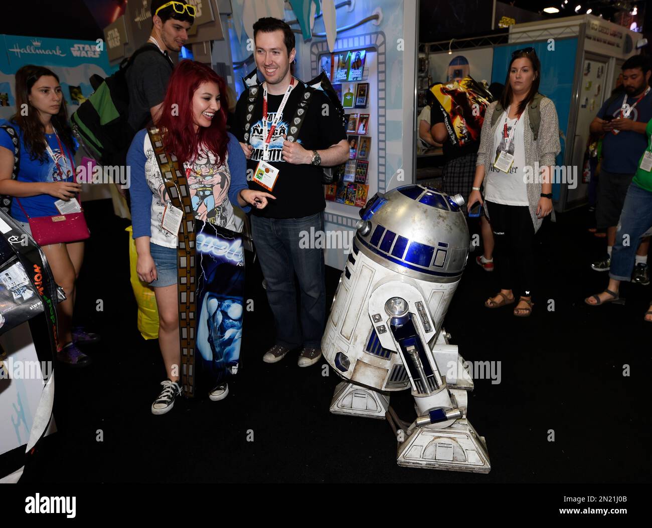 Fans interact with a working prototype of a "Star Wars" R2-D2 robot ...