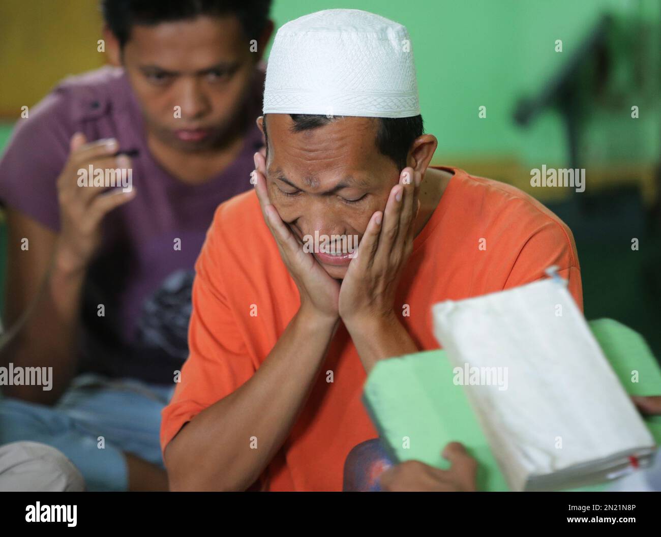 Filipino muslim Munib Dalidig gestures after listening to the Koran at ...