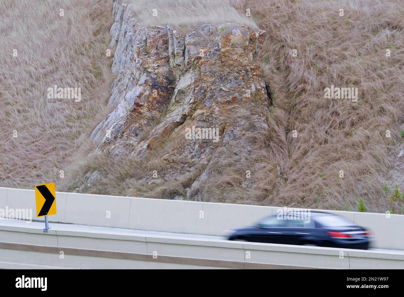 A car passes by a large rock outcrop at the Interstate 430, Interstate ...