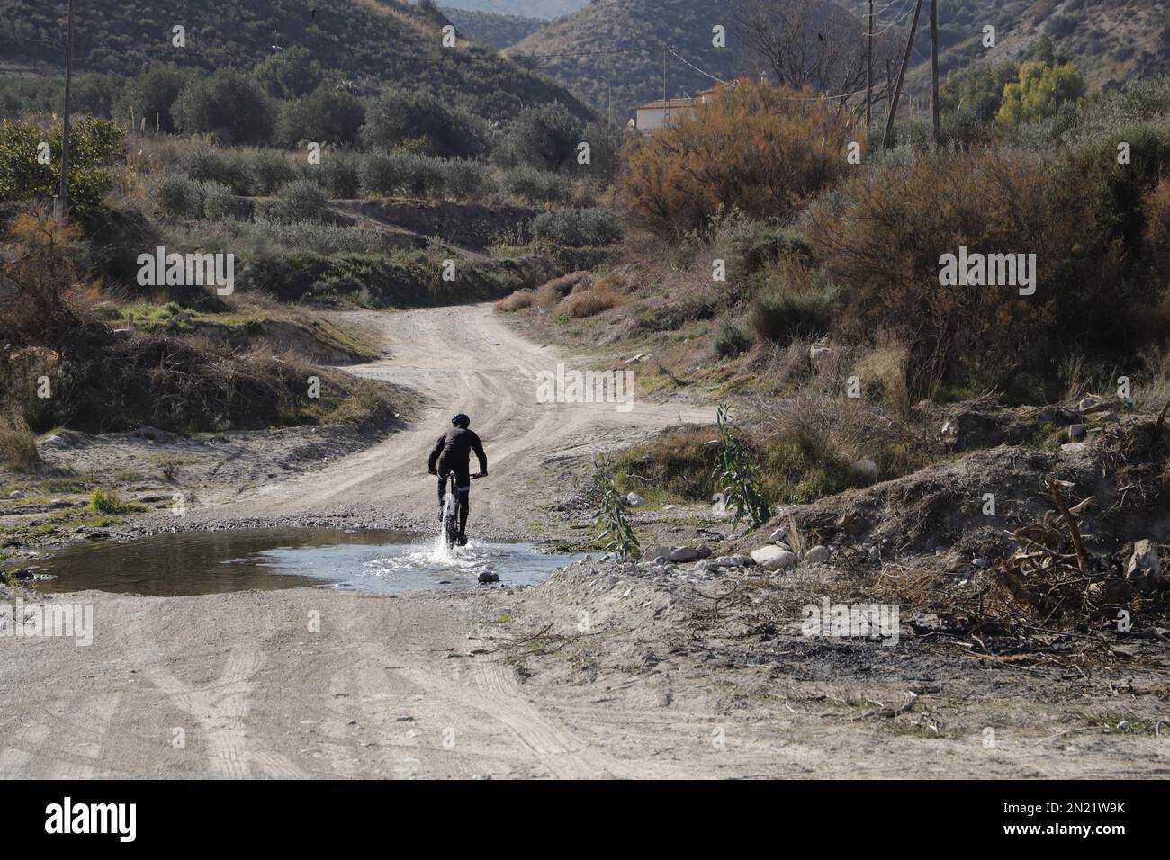Mountainbiker drives through river Stock Photo - Alamy