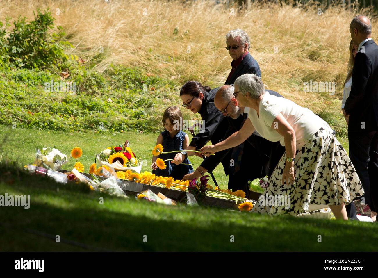 Australia's Gill Hicks, second left, who lost both her legs, lays a ...