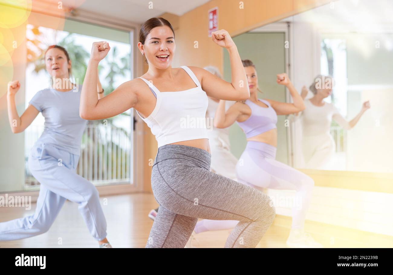 Active young woman practicing aerobic dance in training hall Stock ...