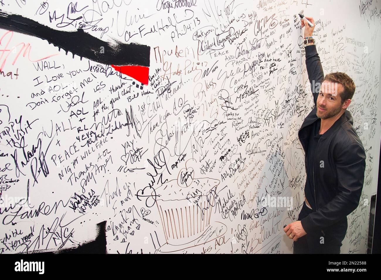 Ryan Reynolds signs the wall at AOL Studios after participating in AOL ...