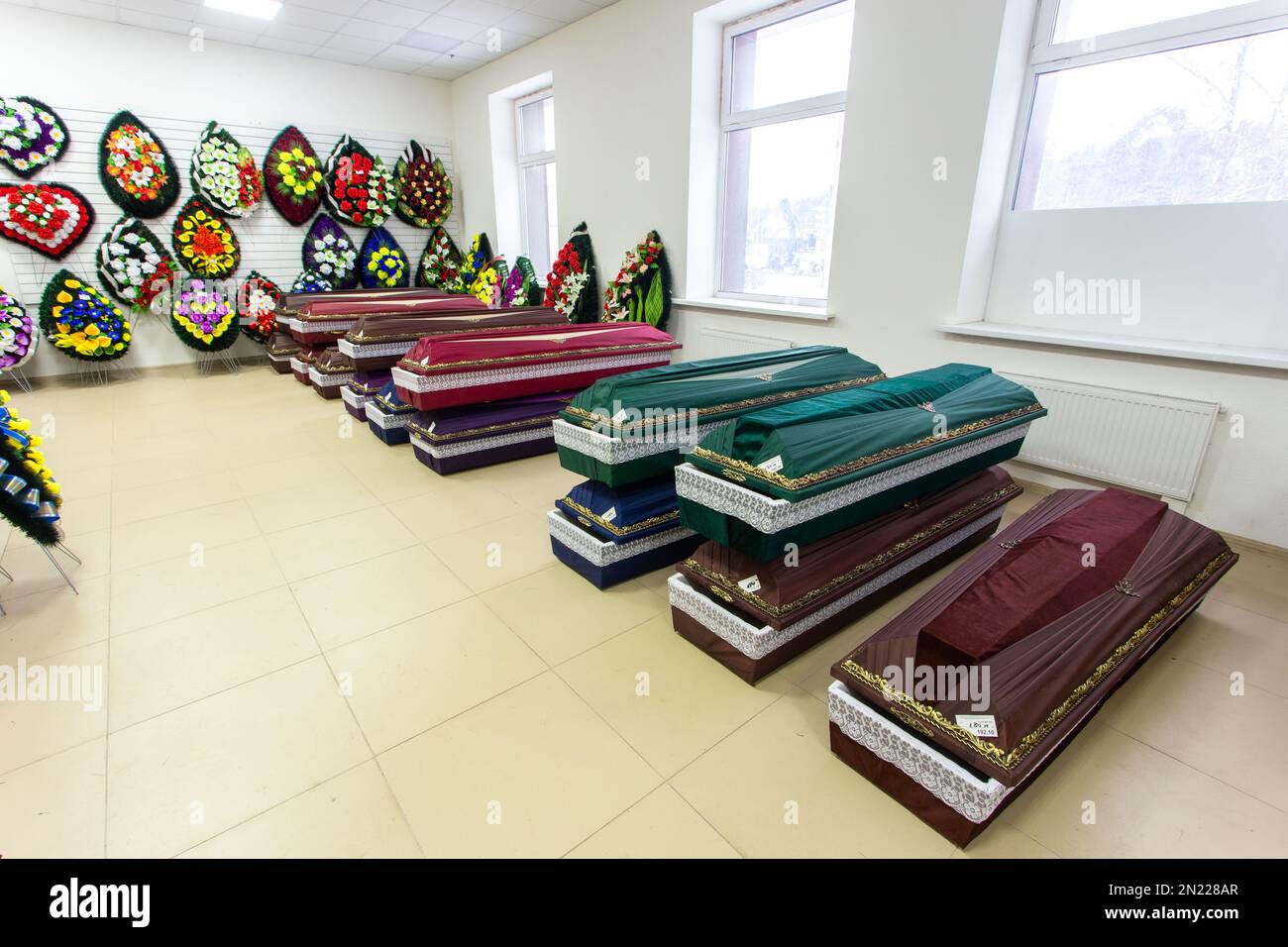 Interior of room with funeral accessories. Shop selling coffins ...