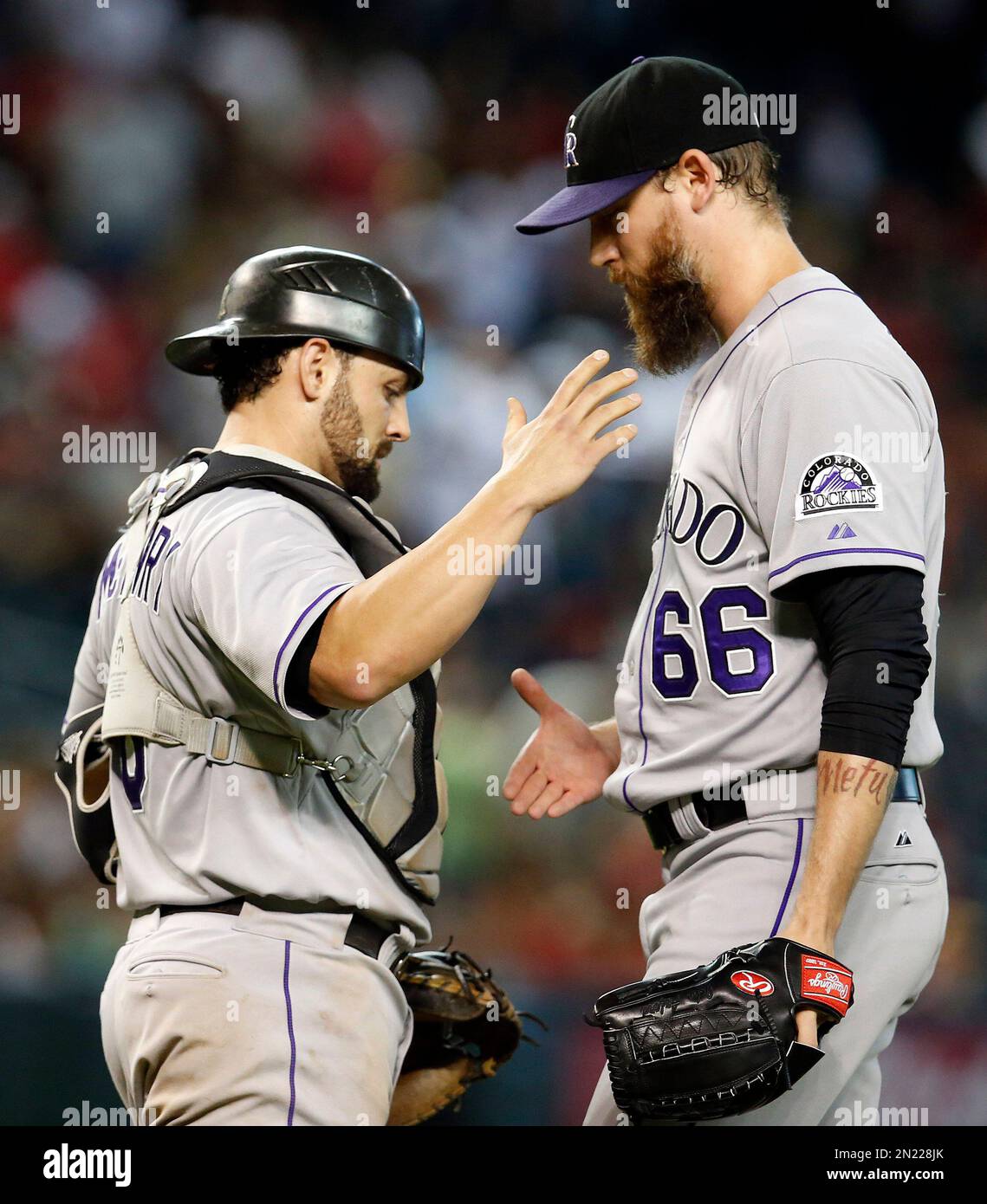 Colorado Rockies catcher Michael McKenry, left, and John Axford, right ...