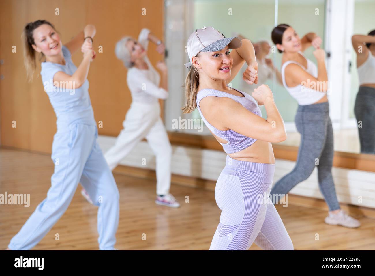 Active people practicing lindy hop movements in dance class Stock Photo ...