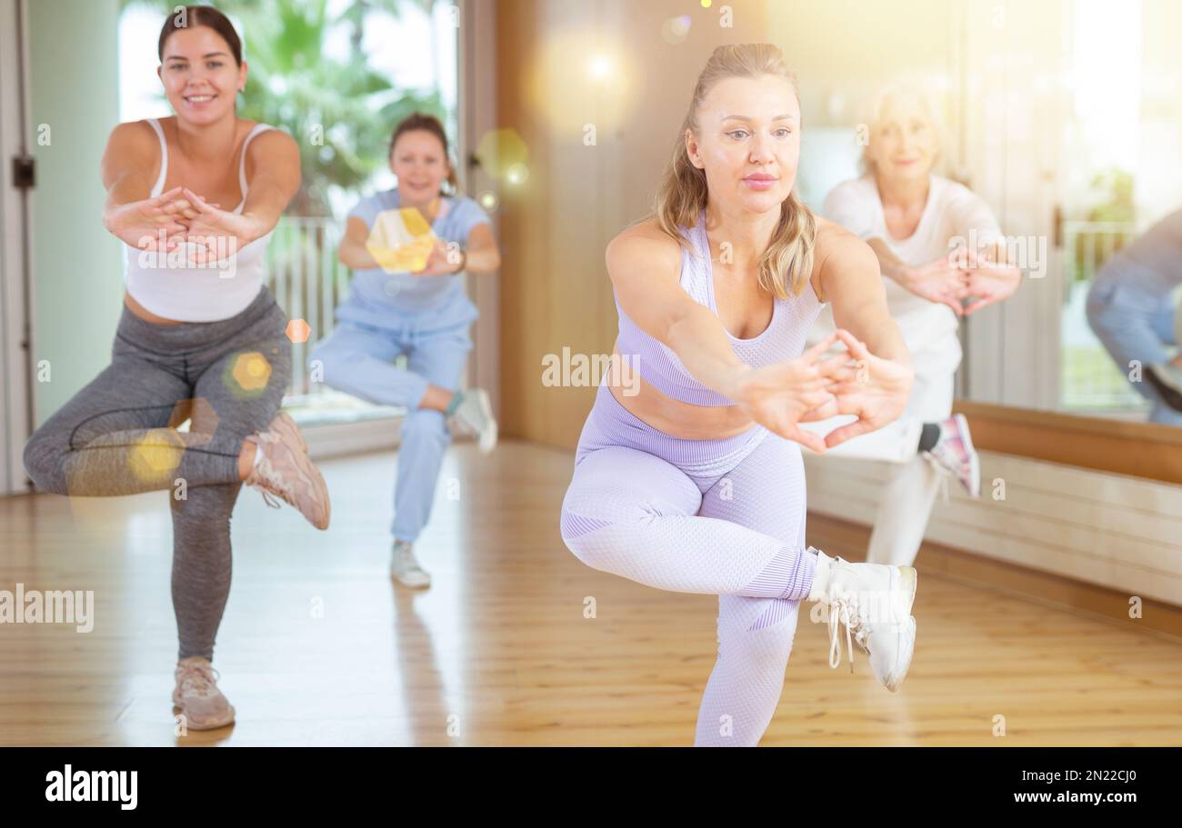 Group are practising arch movement in step jazz dance in fitness gym ...