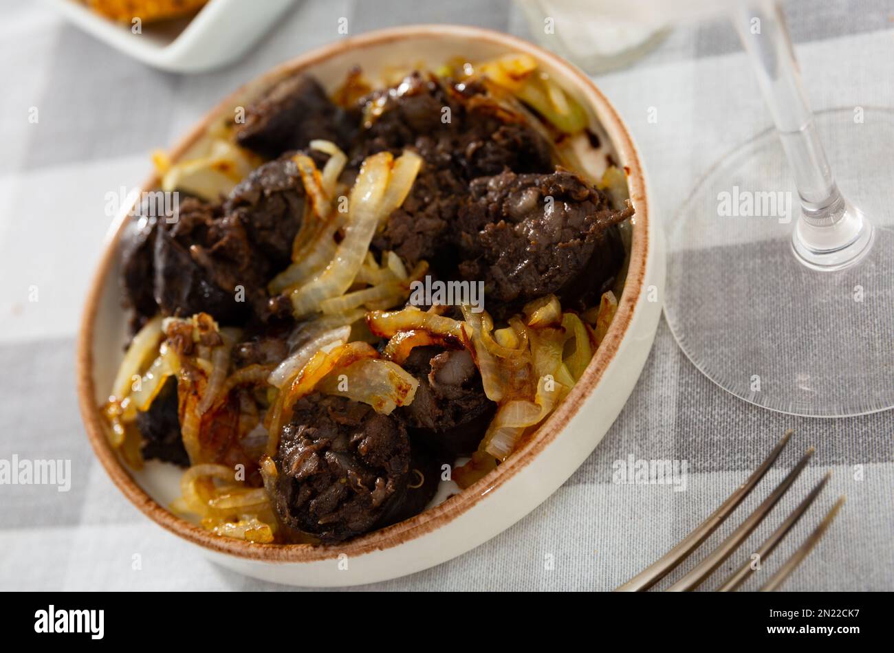 Traditional Spanish morcilla blood sausage served with onions Stock ...