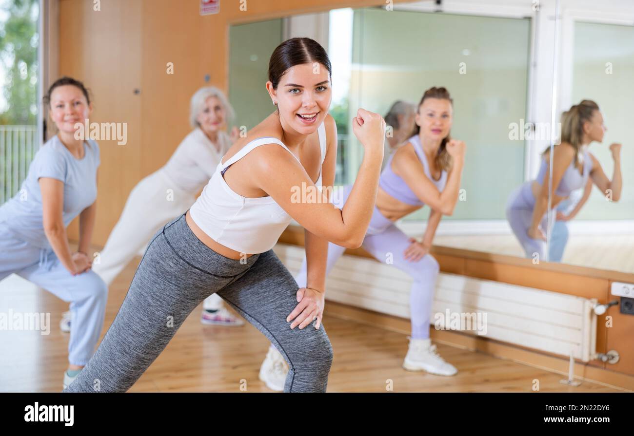 Active young woman practicing aerobic dance in training hall Stock ...