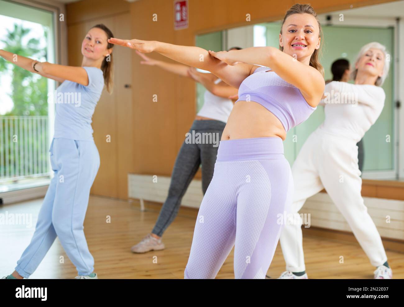 Group are practising arch movement in step jazz dance in fitness gym ...