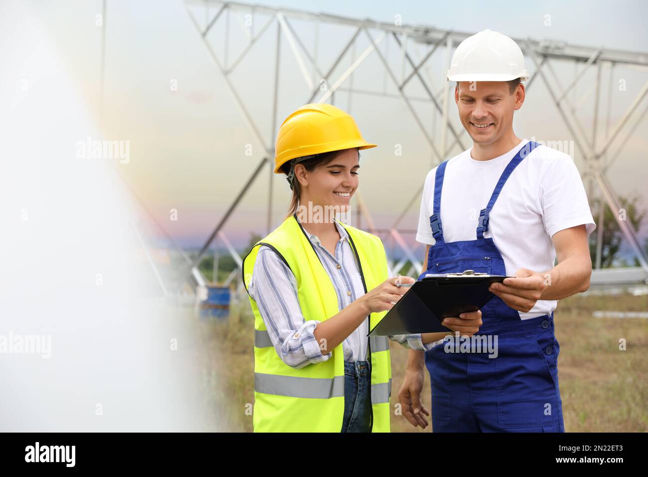 Professional engineers working on installation of electrical substation ...