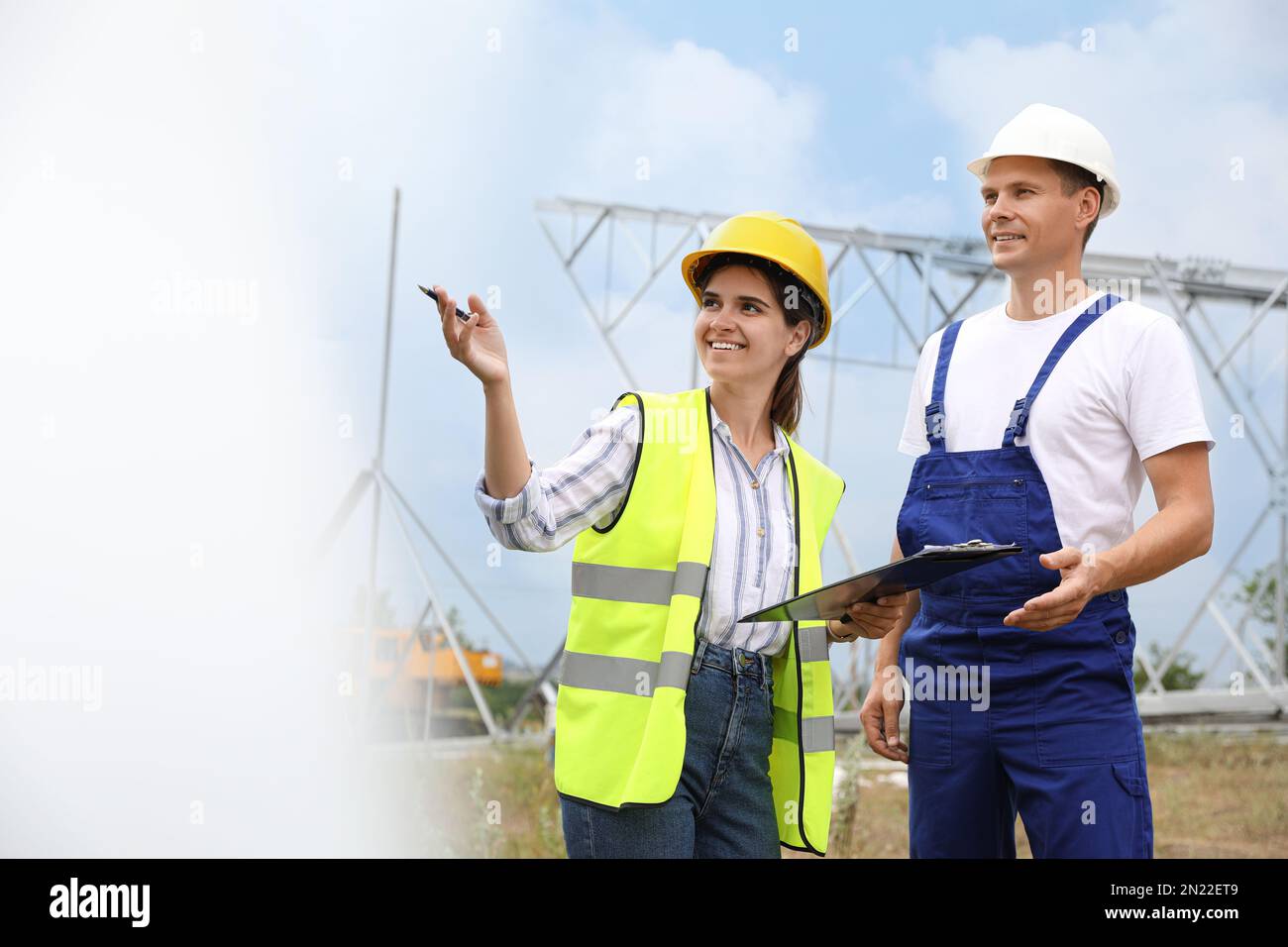 Professional engineers working on installation of electrical substation ...