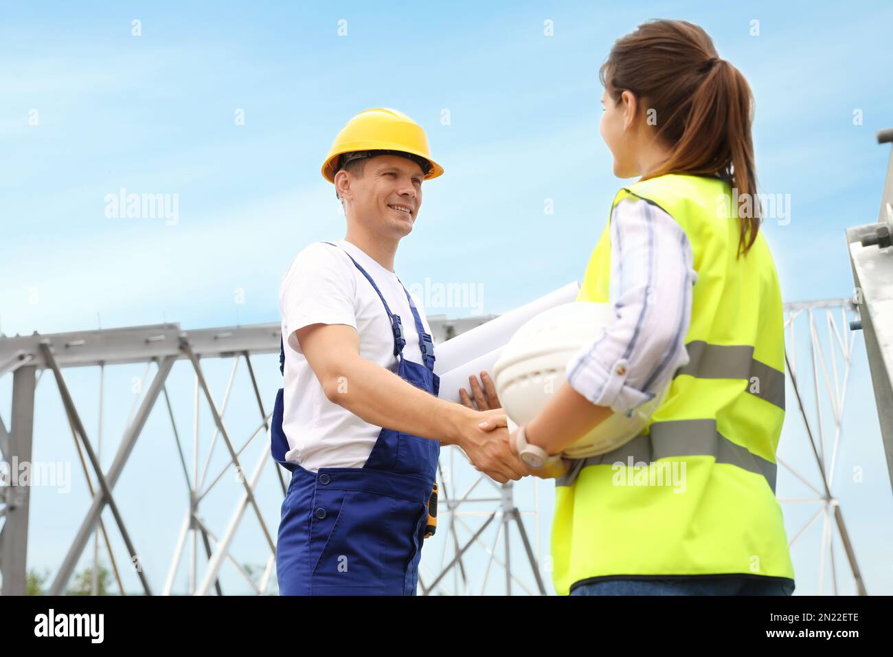Professional engineers working on installation of electrical substation ...