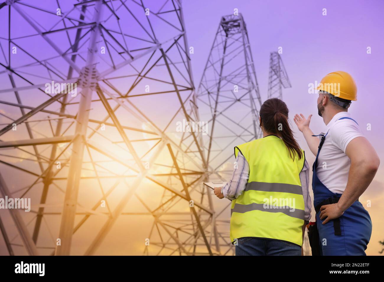 Professional engineers working on installation of electrical substation ...