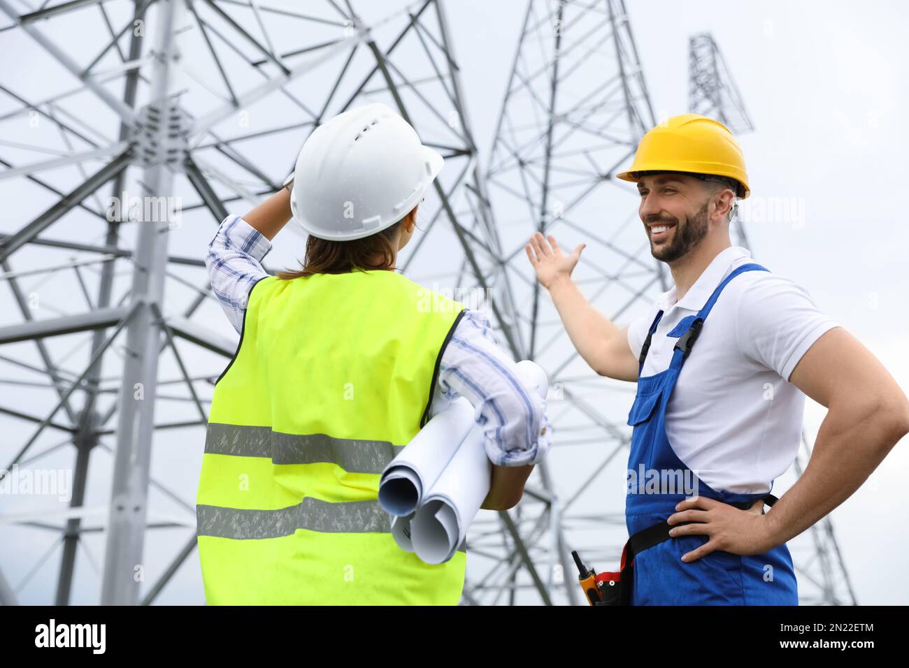 Professional engineers working on installation of electrical substation ...