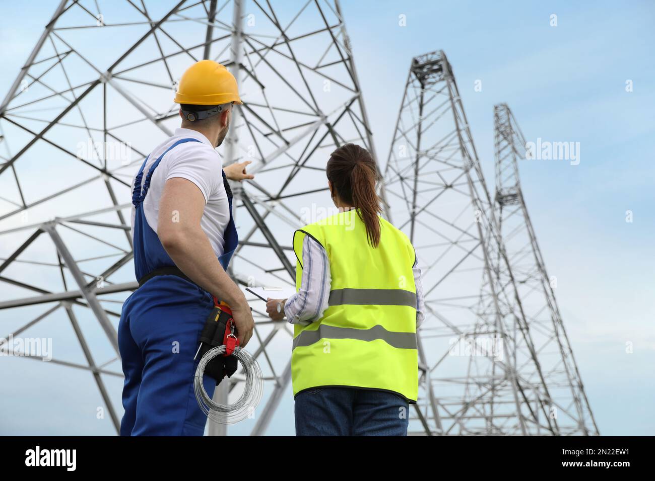 Professional engineers working on installation of electrical substation ...