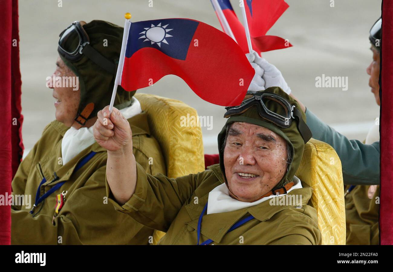 Taiwan's WWII military veterans wave to spectators during a massive ...