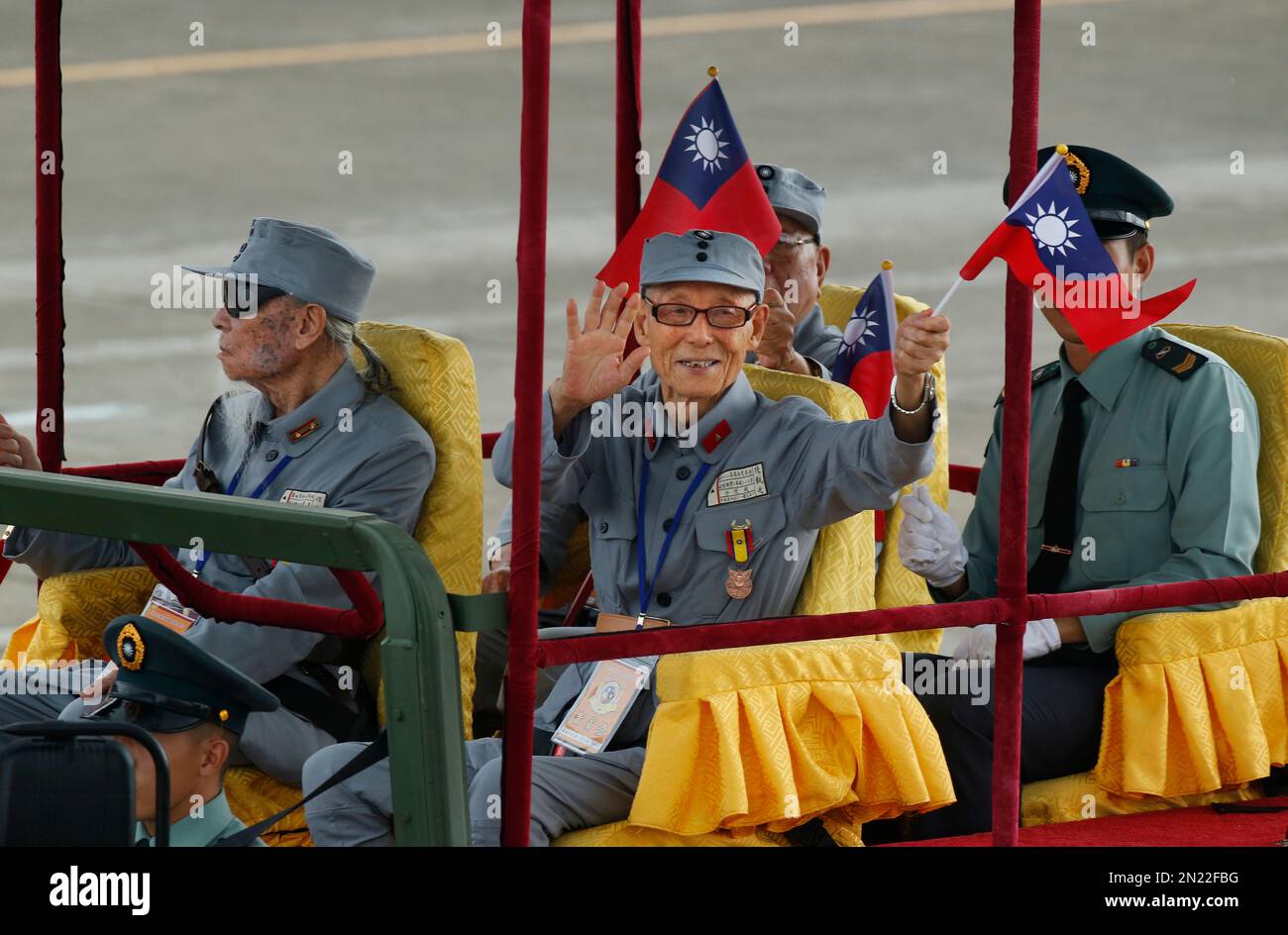 Taiwan's WWII military veterans wave to spectators during a massive ...