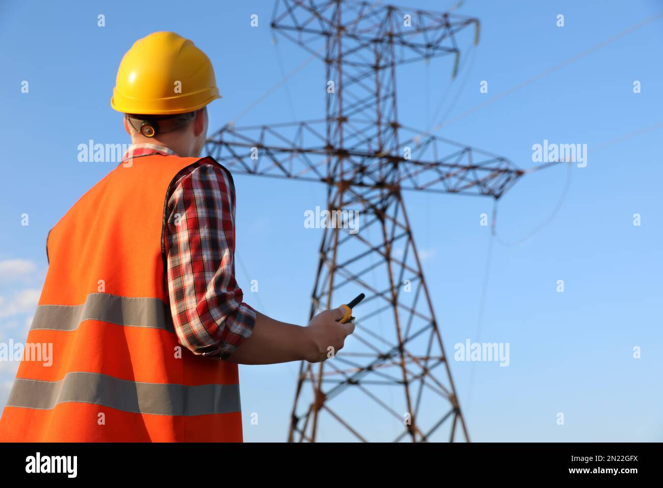 Electrical engineer with walkie talkie near high voltage tower Stock ...