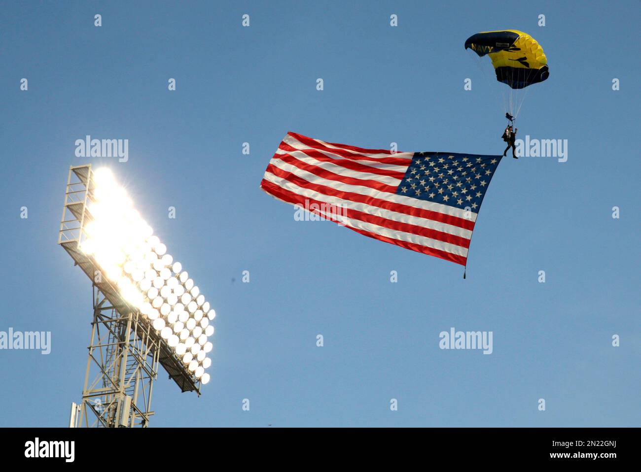 U.S. Navy Seal parachute team lands on the field prior to a baseball ...