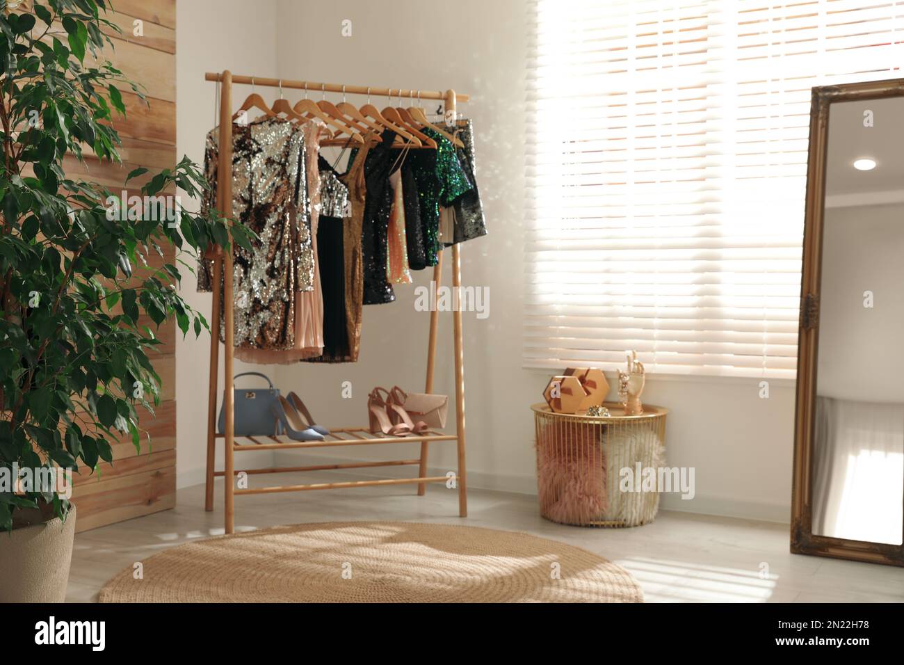 Rack with stylish women's clothes in room. Interior design Stock Photo ...