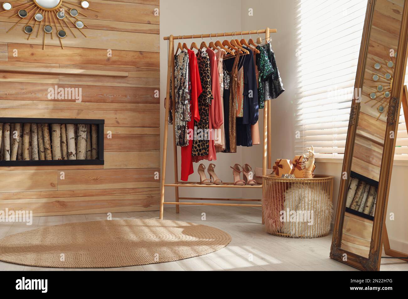 Rack with stylish women's clothes in room. Interior design Stock Photo ...