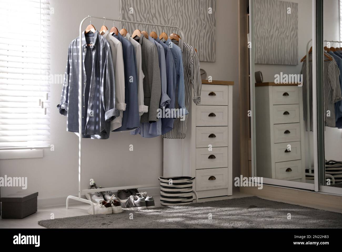 Dressing room interior with clothing rack and chest of drawers Stock ...