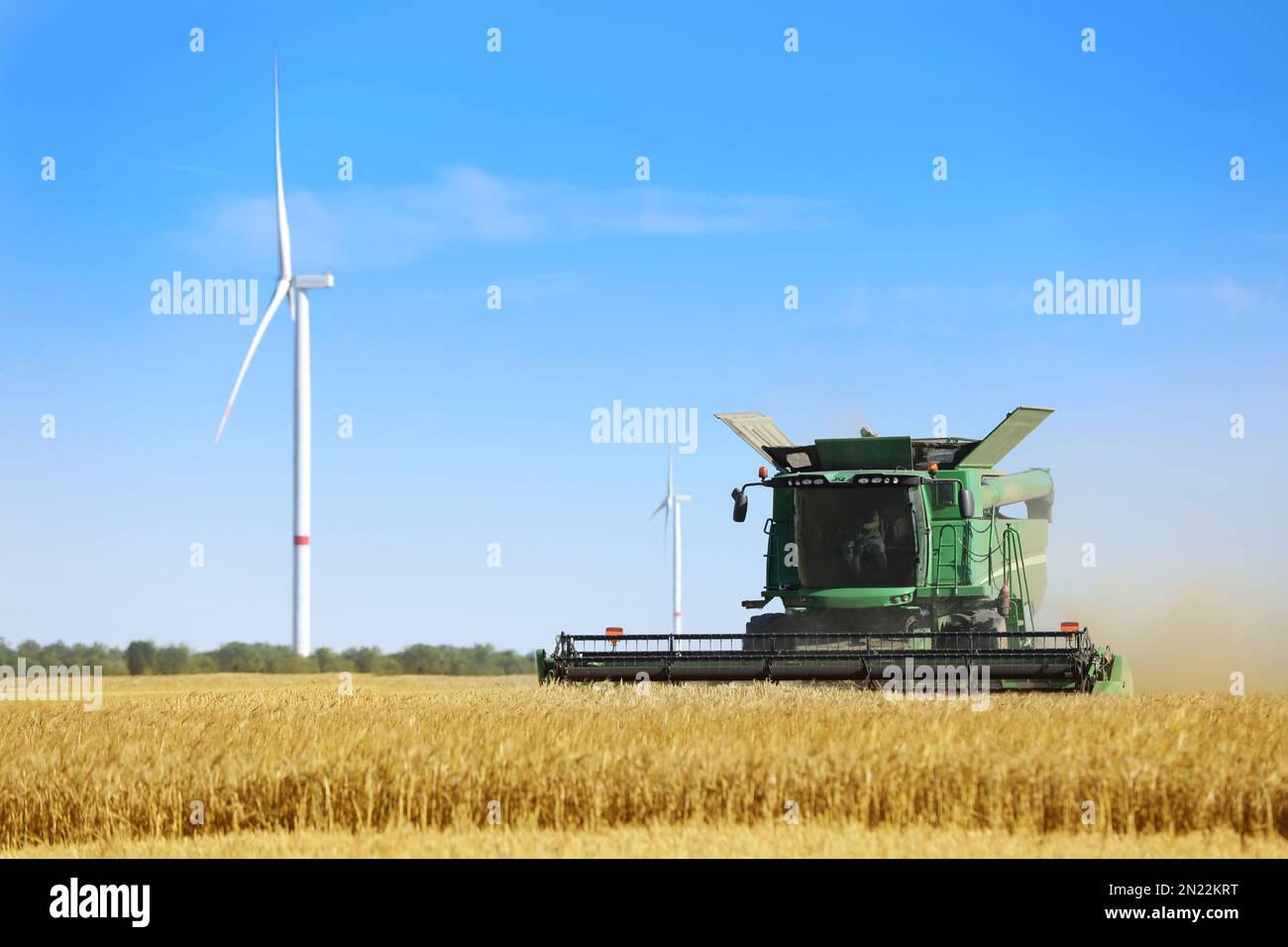 Modern combine harvester working in agricultural field Stock Photo - Alamy