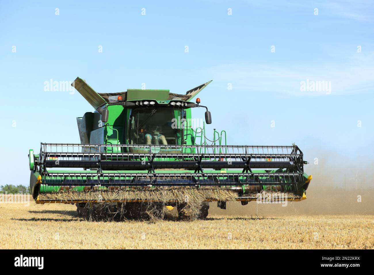 Modern combine harvester working in agricultural field Stock Photo - Alamy