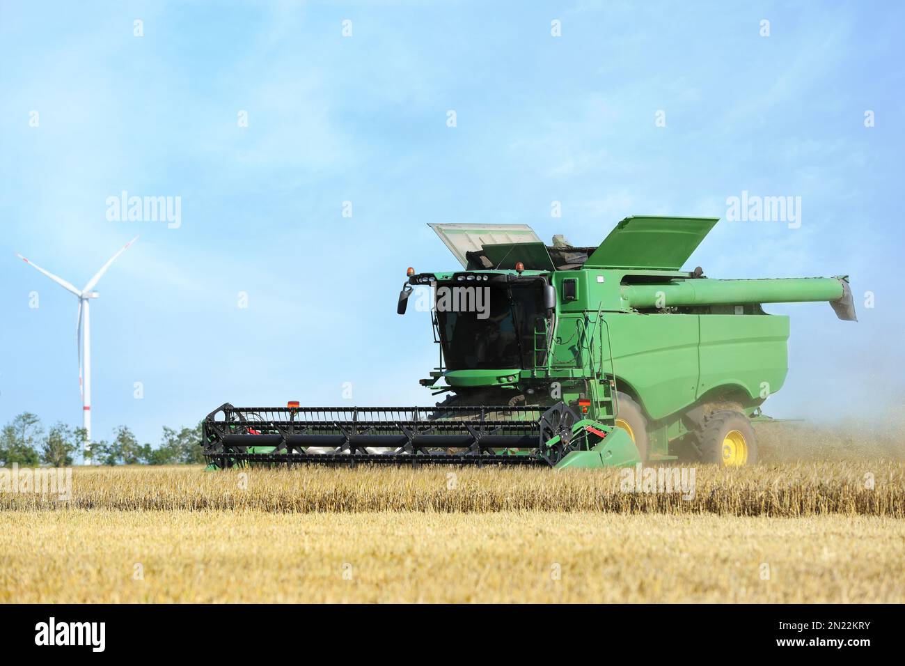 Modern combine harvester working in agricultural field Stock Photo - Alamy