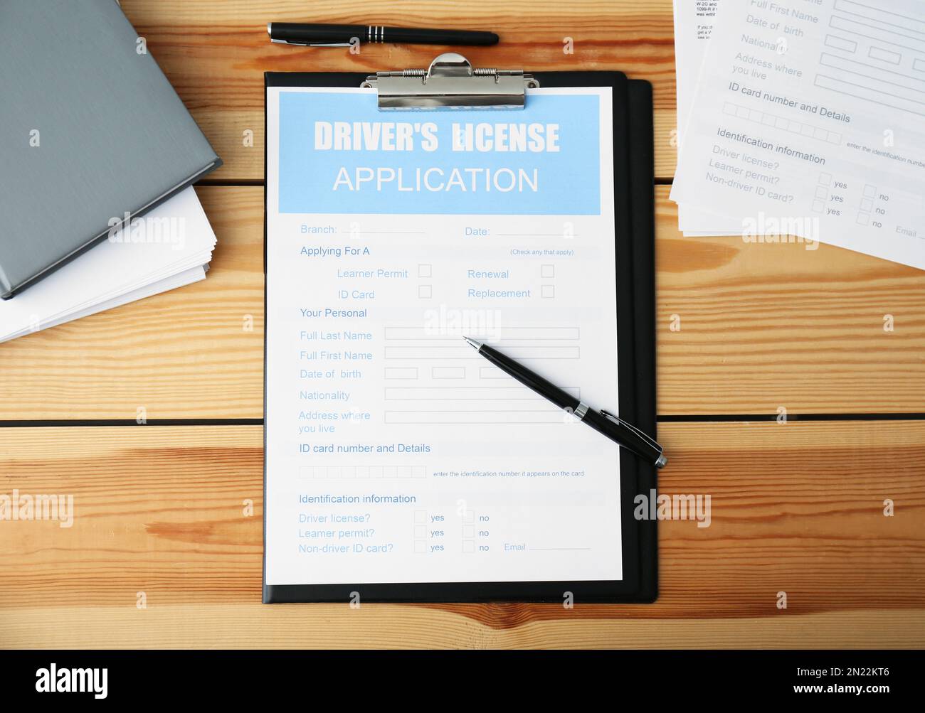 Driver's license application form, documents and stationery on wooden table, flat lay Stock ...