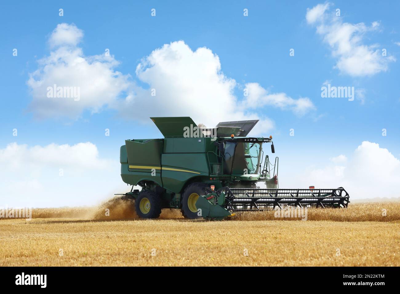 Modern combine harvester working in agricultural field Stock Photo - Alamy