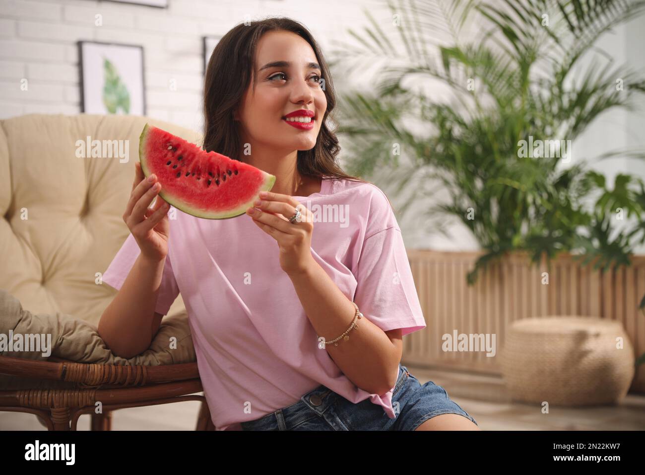 Beautiful young woman with watermelon at home Stock Photo - Alamy