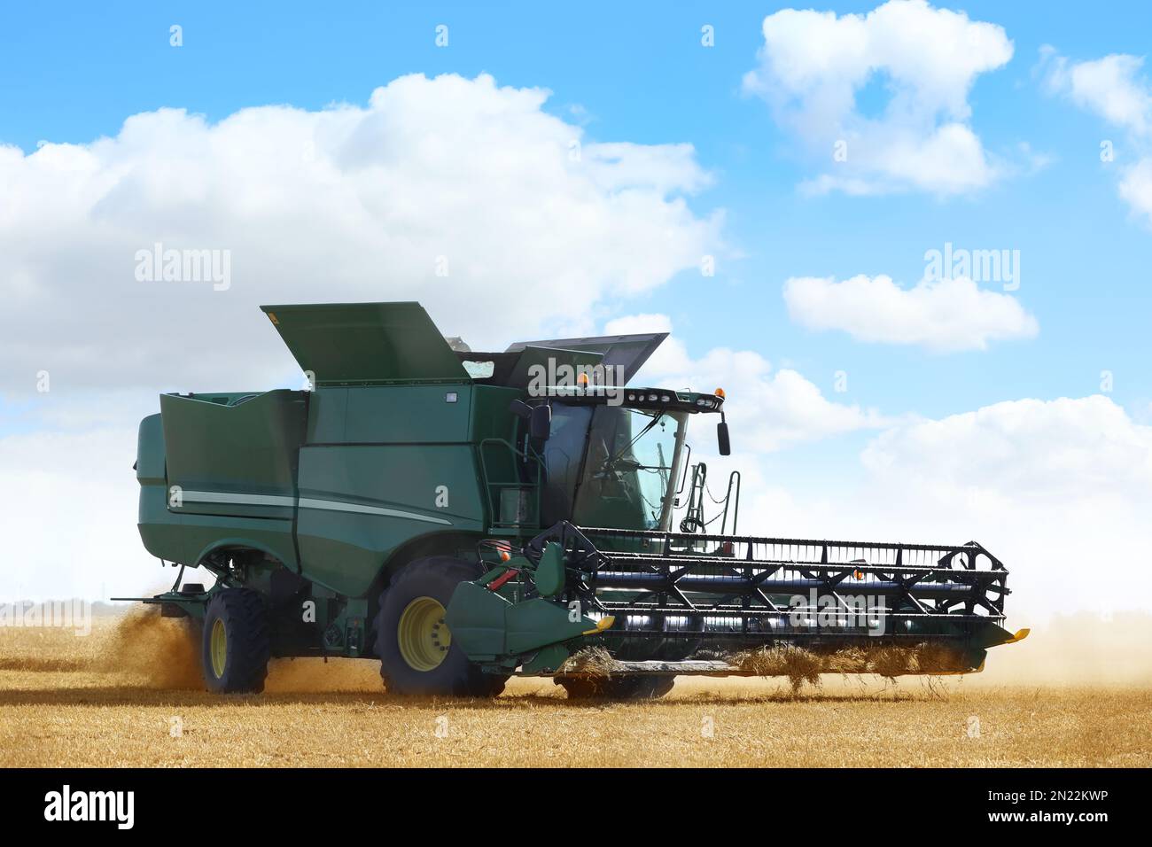 Modern combine harvester working in agricultural field Stock Photo - Alamy