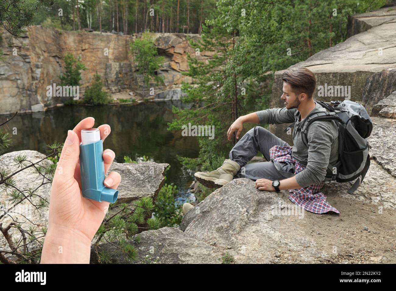 Woman with asthma inhaler and her boyfriend near lake. Emergency first ...