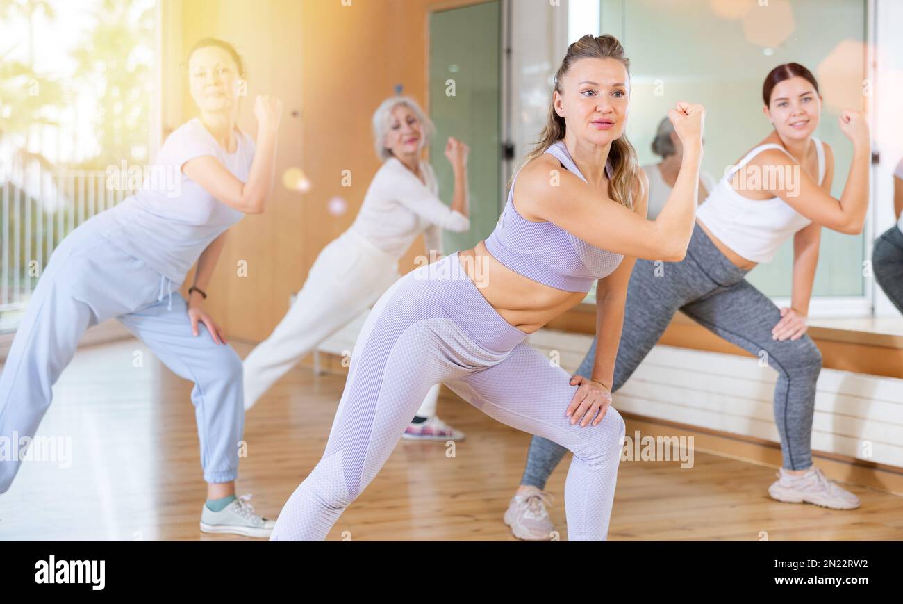 Active people practicing lindy hop movements in dance class Stock Photo ...