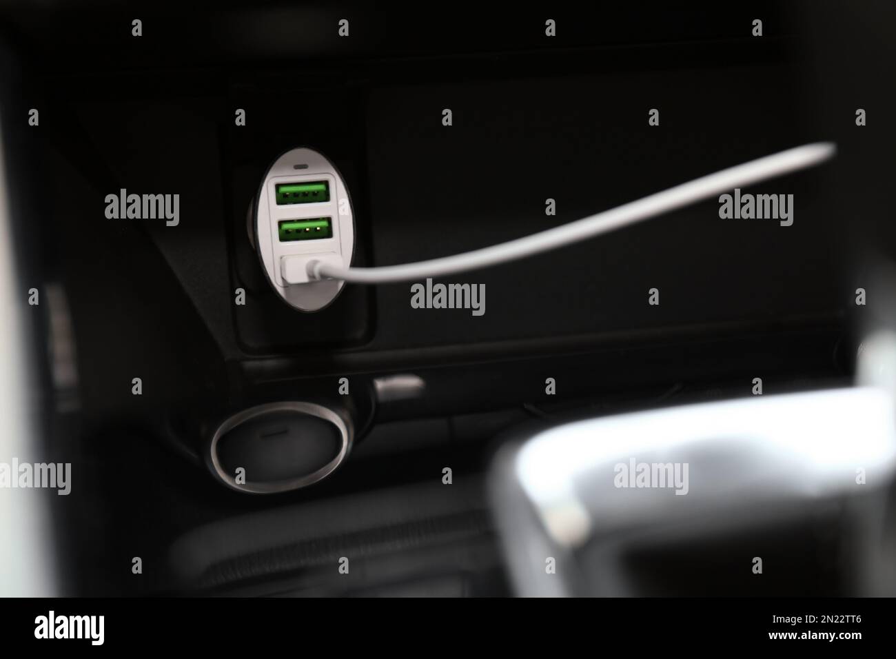 Charging cable connected to plug in car, closeup Stock Photo - Alamy