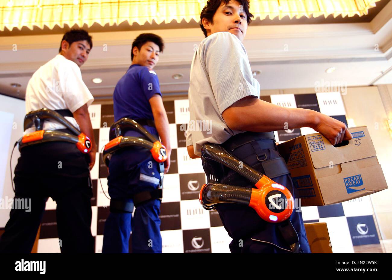 Employees at Haneda international airport wearing HAL (hybrid assistive ...