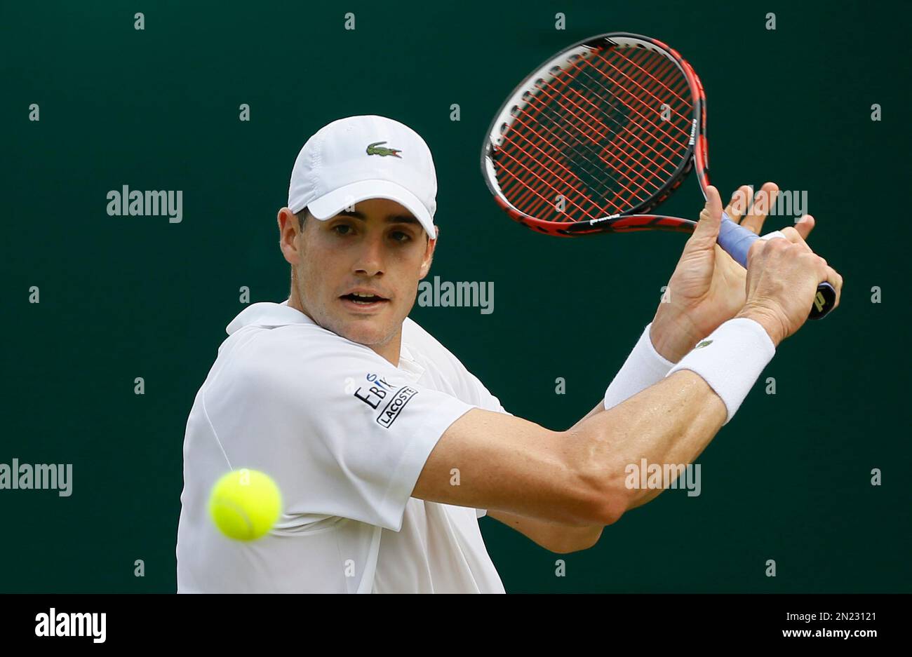 John Isner of the United States returns a shot to Matthew Ebden of ...