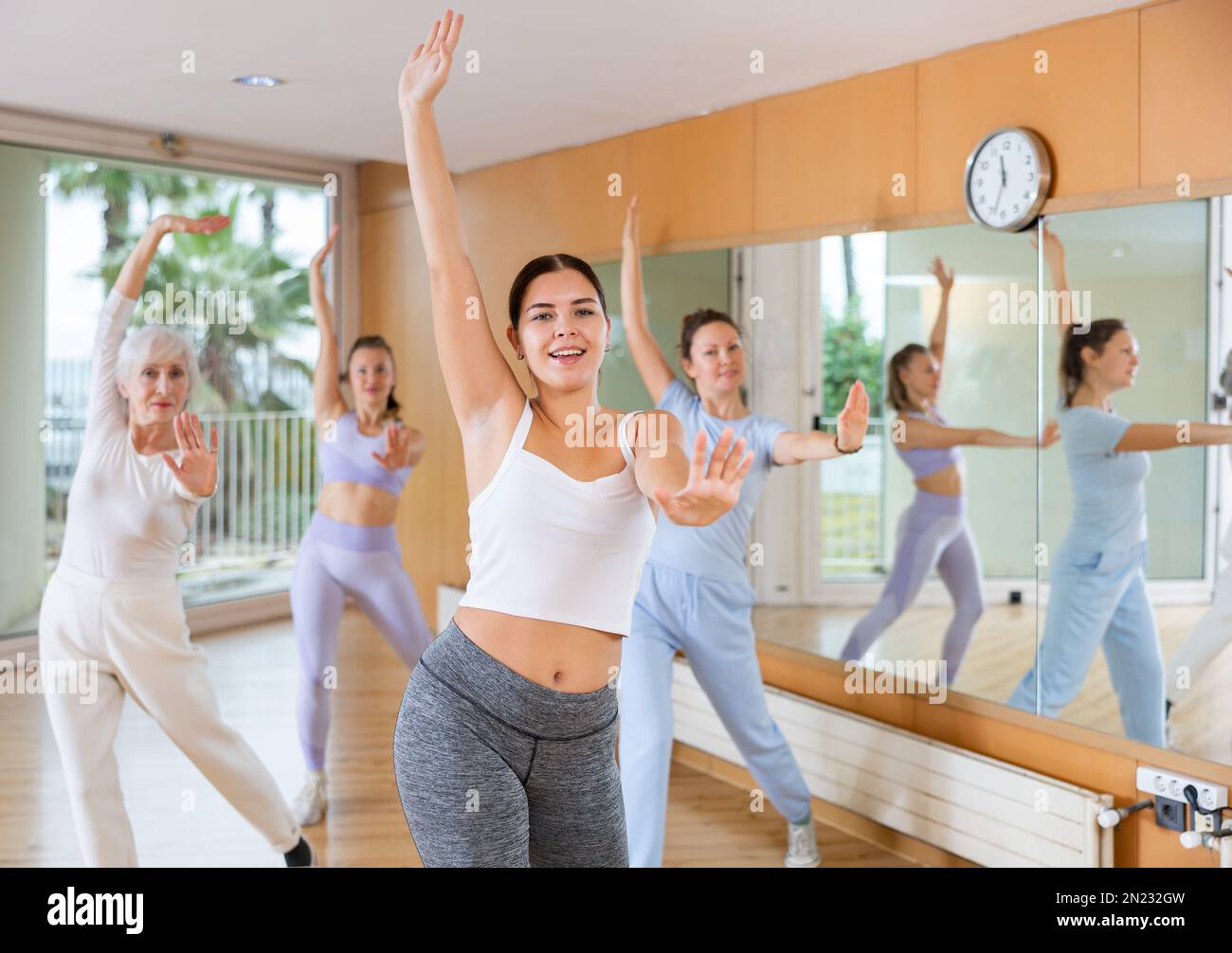 Women learning modern dance movements at class together Stock Photo - Alamy