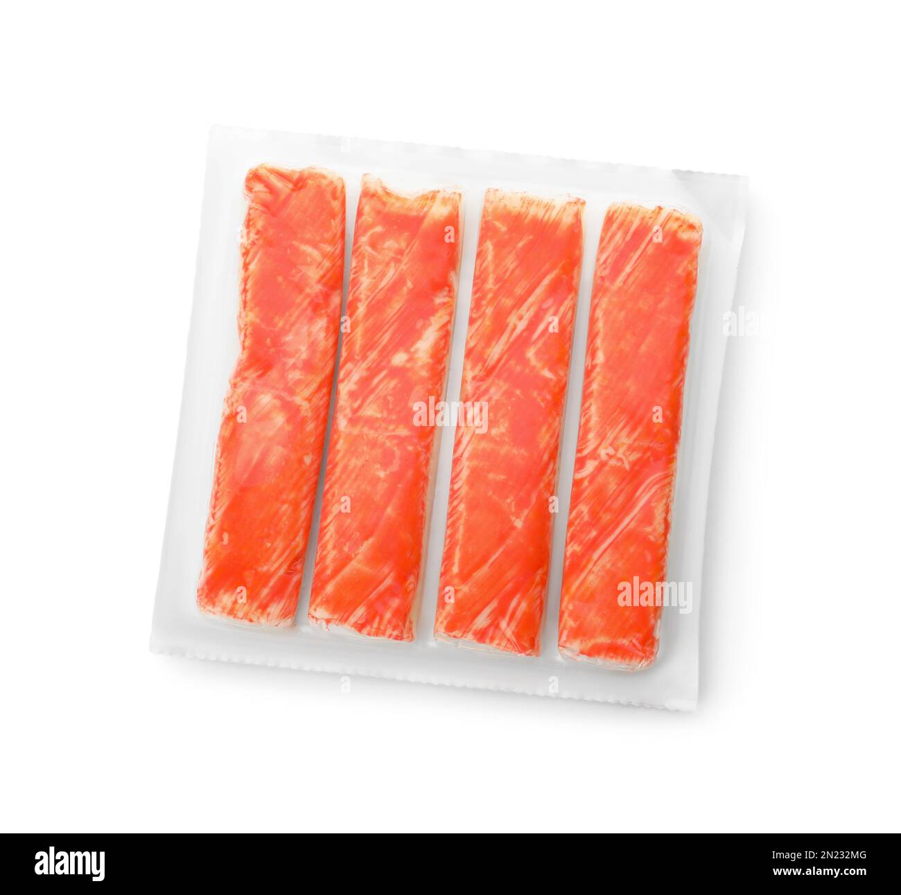 Delicious crab sticks in plastic packaging isolated on white, top view ...