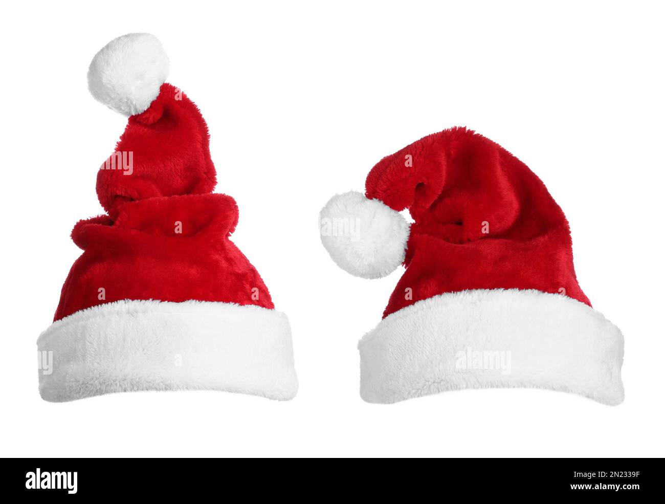 Two red Santa hats on white background Stock Photo - Alamy