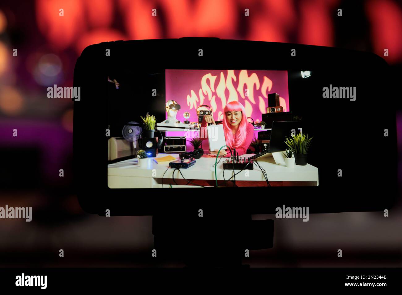 Asian vlogger filming podcast at night in vlogging studio recording ...