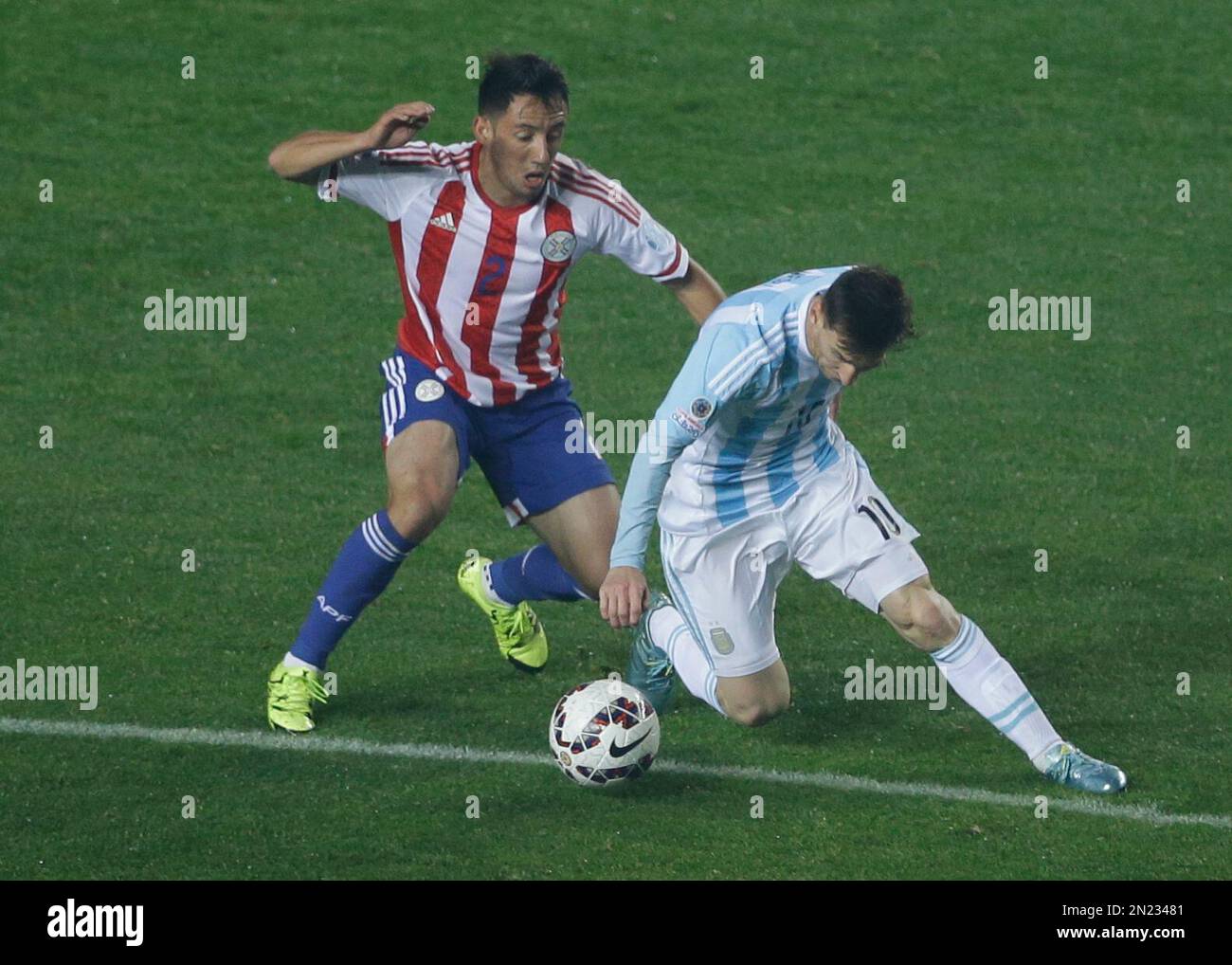 Argentina's Lionel Messi, right, avoids Paraguay's Bruno Valdez on the ...