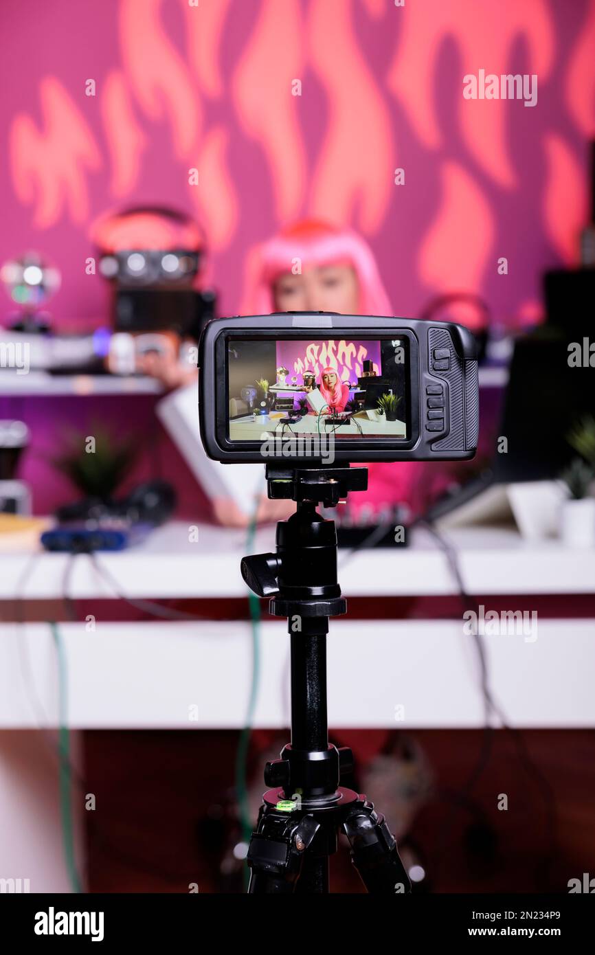Content creator filming white box review in recording studio talking ...
