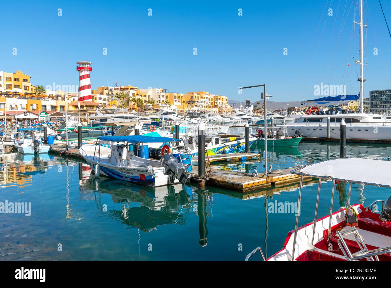 The colorful and busy cruise port with shops, cafes and boats in the ...