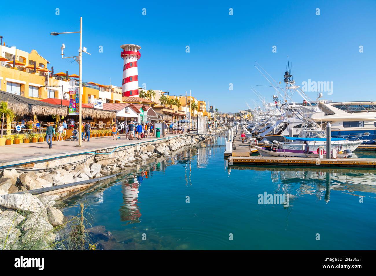 The colorful and busy cruise port with shops, cafes and boats in the ...