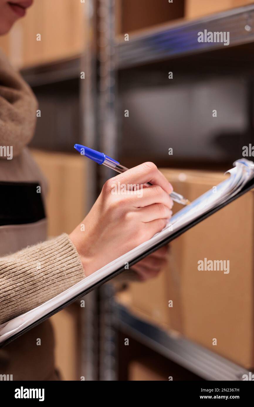Post office warehouse employee searching parcel, checking postal form ...