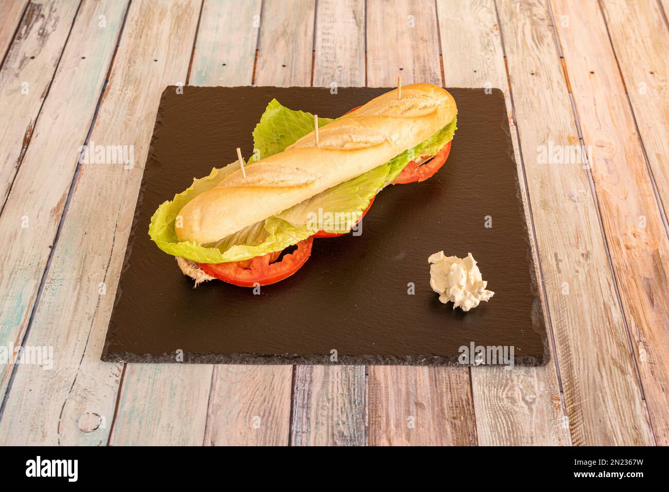 A typical Spanish sandwich with a loaf of baguette stuffed with tomato ...