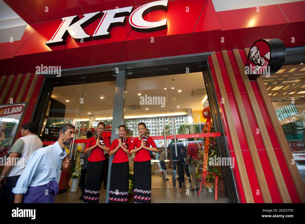 Staff members greet visitors at a newly opened KFC fried chicken ...